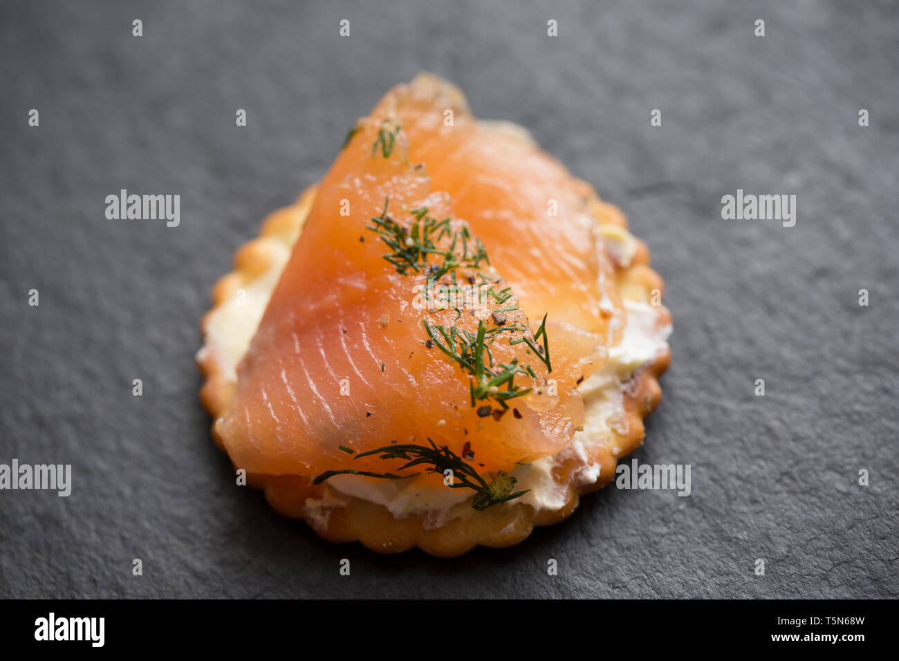 A single slice of gravadlax from a rainbow trout fillet, Oncorhynchus ...