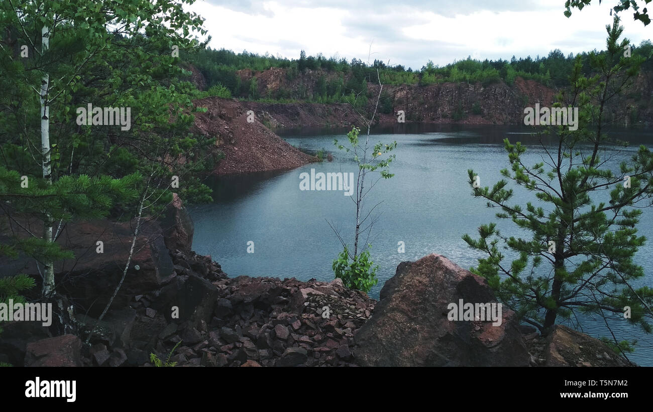 View on inactive abandoned granite quarry with beautiful blue water ...