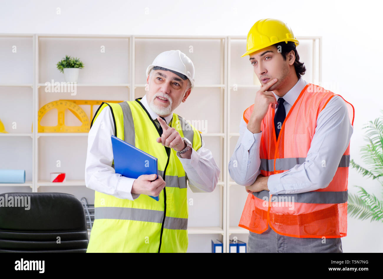 Two engineers colleagues working under project Stock Photo - Alamy