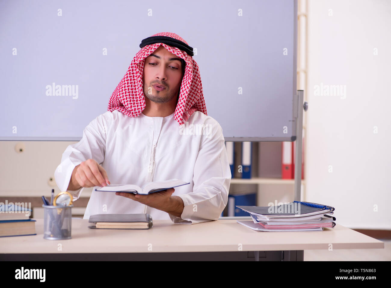 Arab teacher in front of whiteboard Stock Photo - Alamy