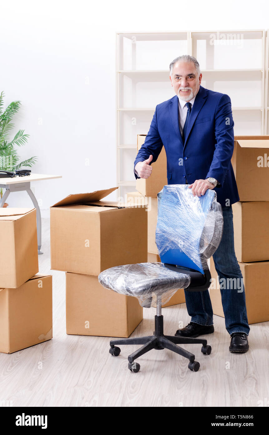 Aged businessman moving to new workplace Stock Photo - Alamy