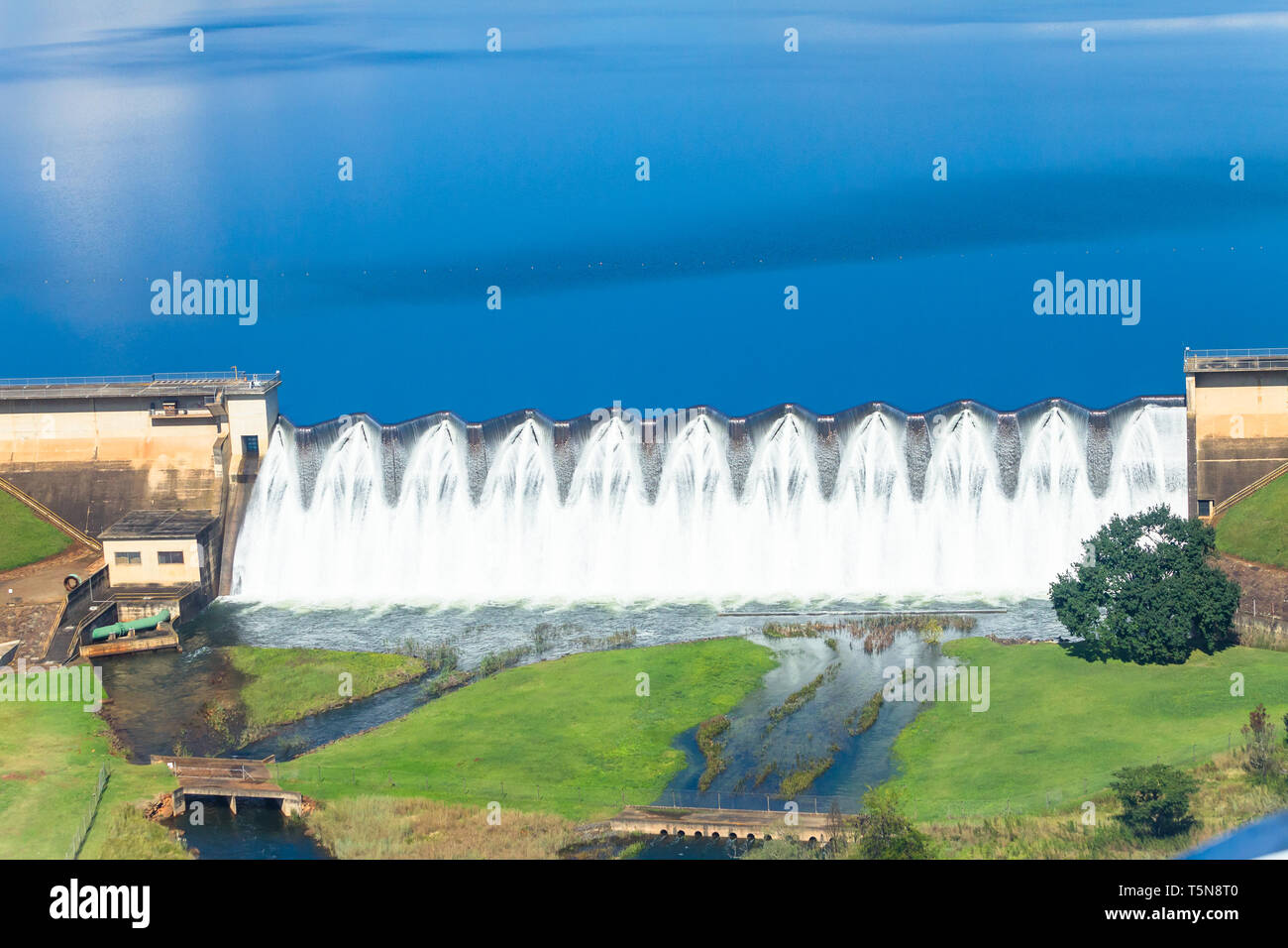 Full dam waters overflowing wall structure closeup flying air photo ...