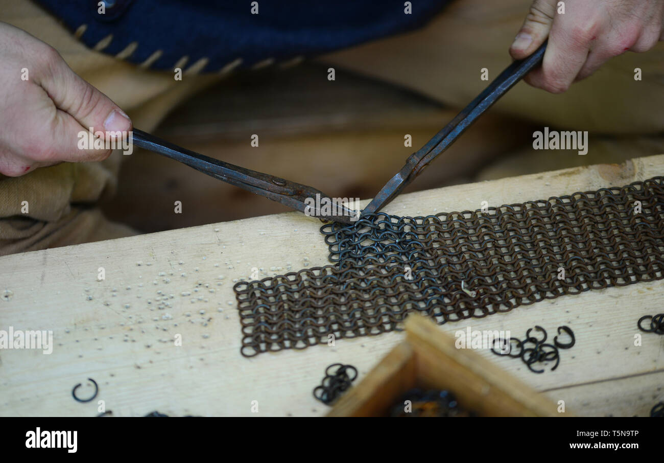 Blacksmith fixing the metal armor hauberk ancient craft Stock Photo - Alamy