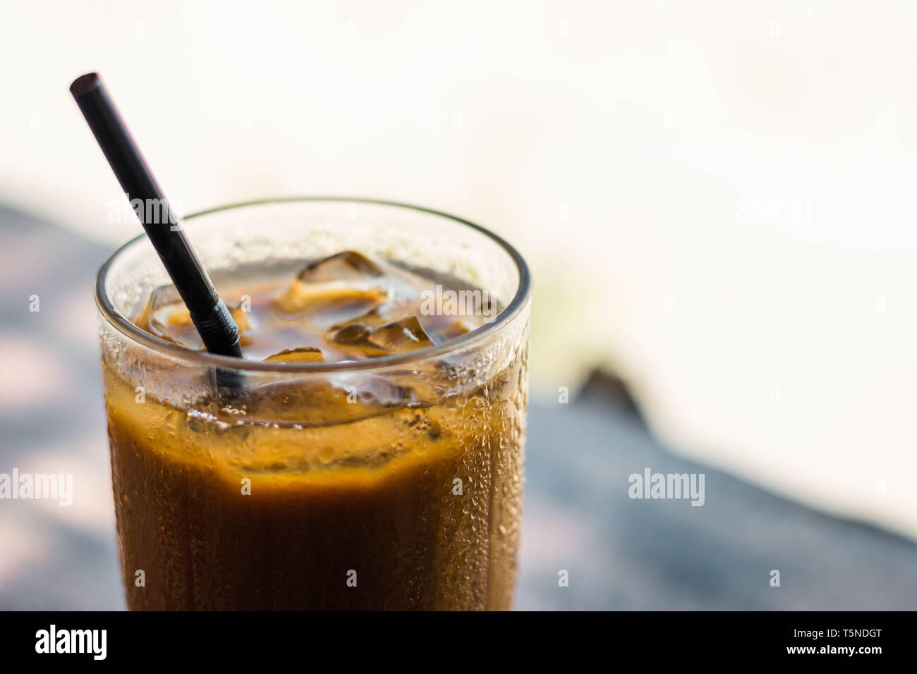 Fresh iced coffee on a wood table in a terrace in summer Stock Photo ...