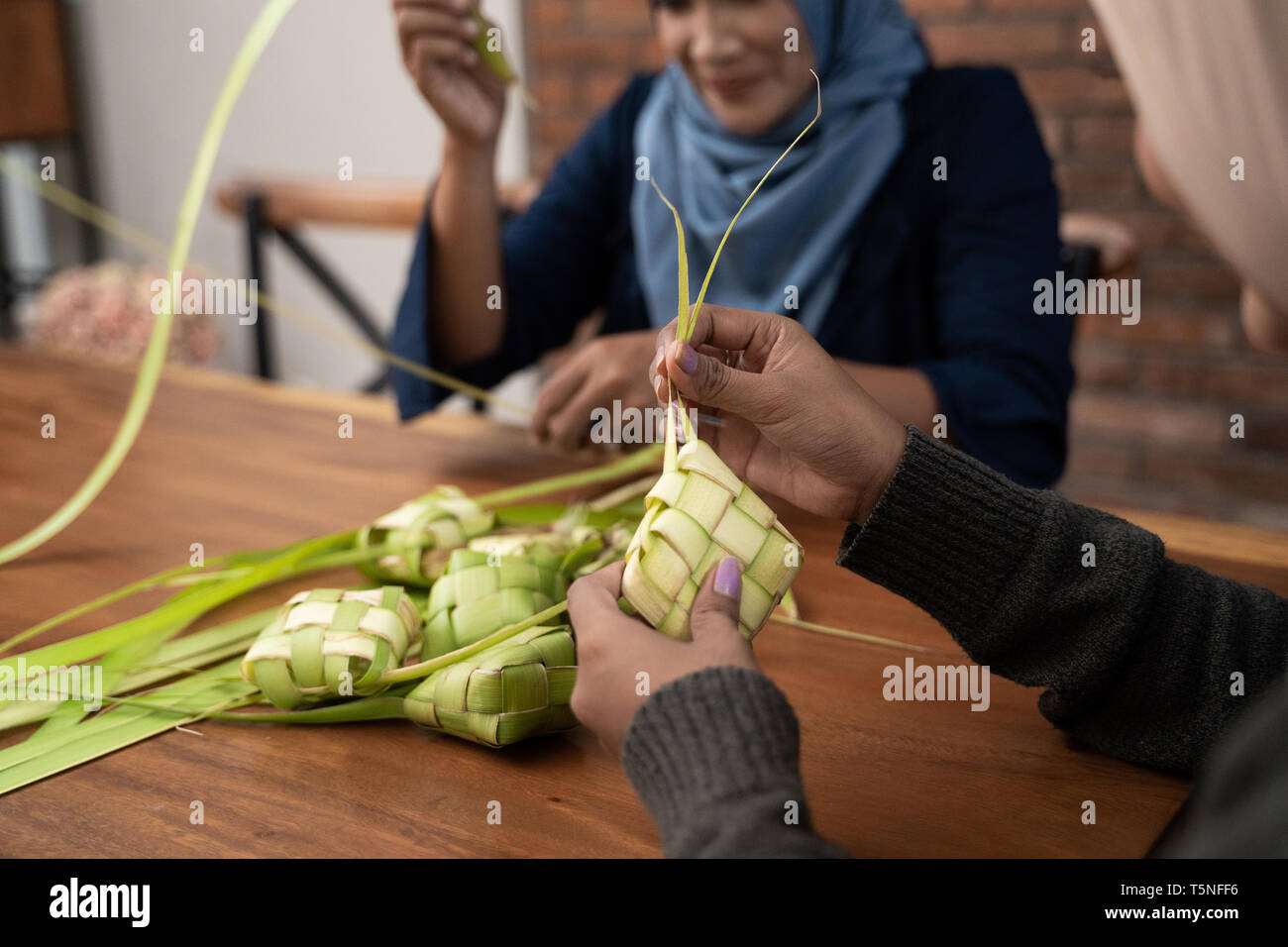 making ketupat traditional indonesian food together Stock Photo - Alamy