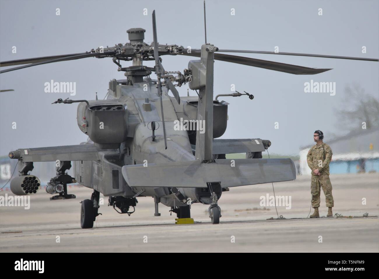 A 12th Combat Aviation Brigade Apache crewmember prefights his aircraft ...