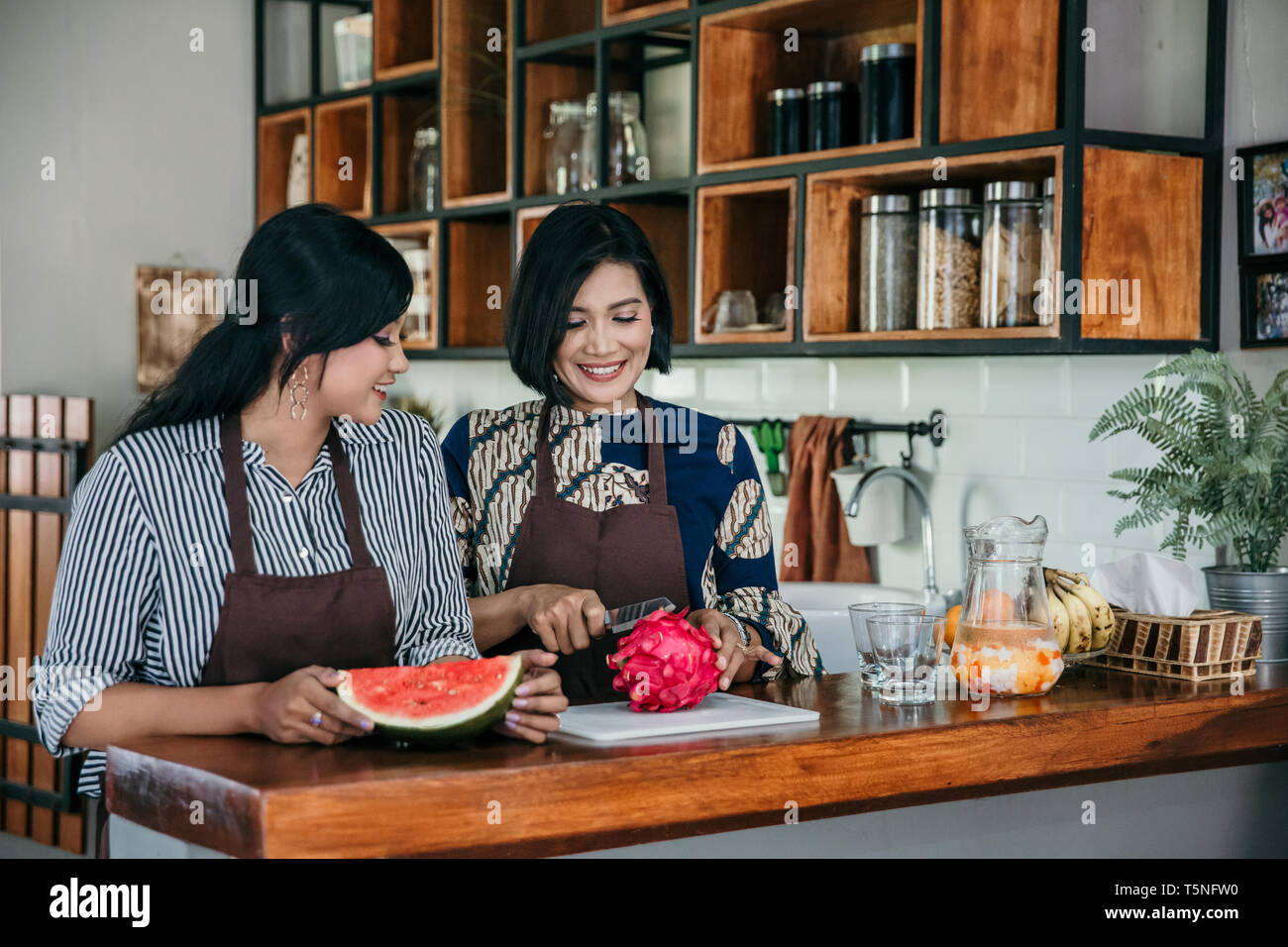 mother and daughter at home making some fresh dessert Stock Photo - Alamy