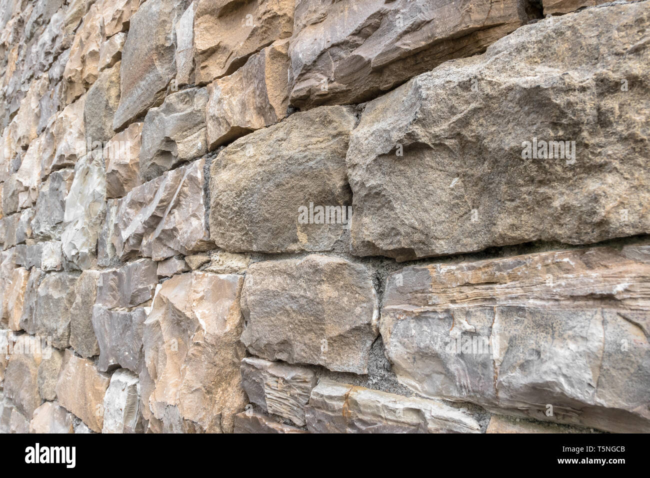 Stone wall. Oblique angle. Ideal for background Stock Photo - Alamy