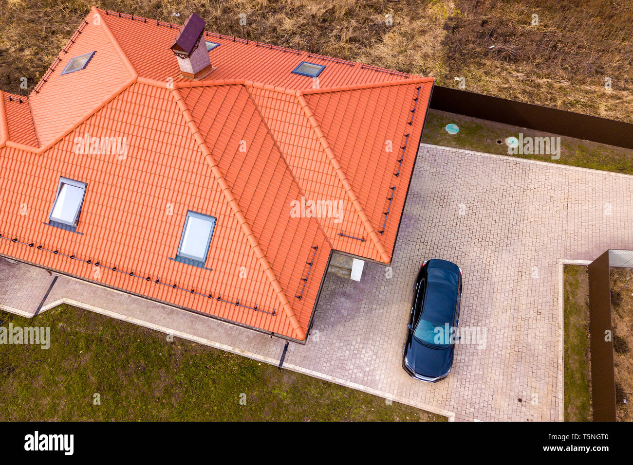 Aerial top view of house metal shingle roof with attic windows and ...