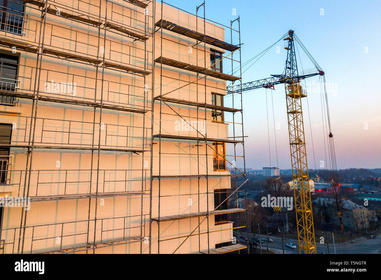 Apartment or office tall unfinished building under construction. Brick ...