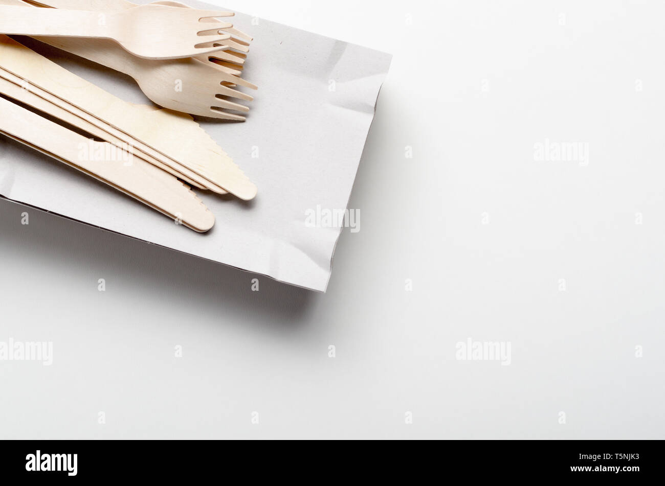 Wooden single use kitchenware and paper plate on white background ...