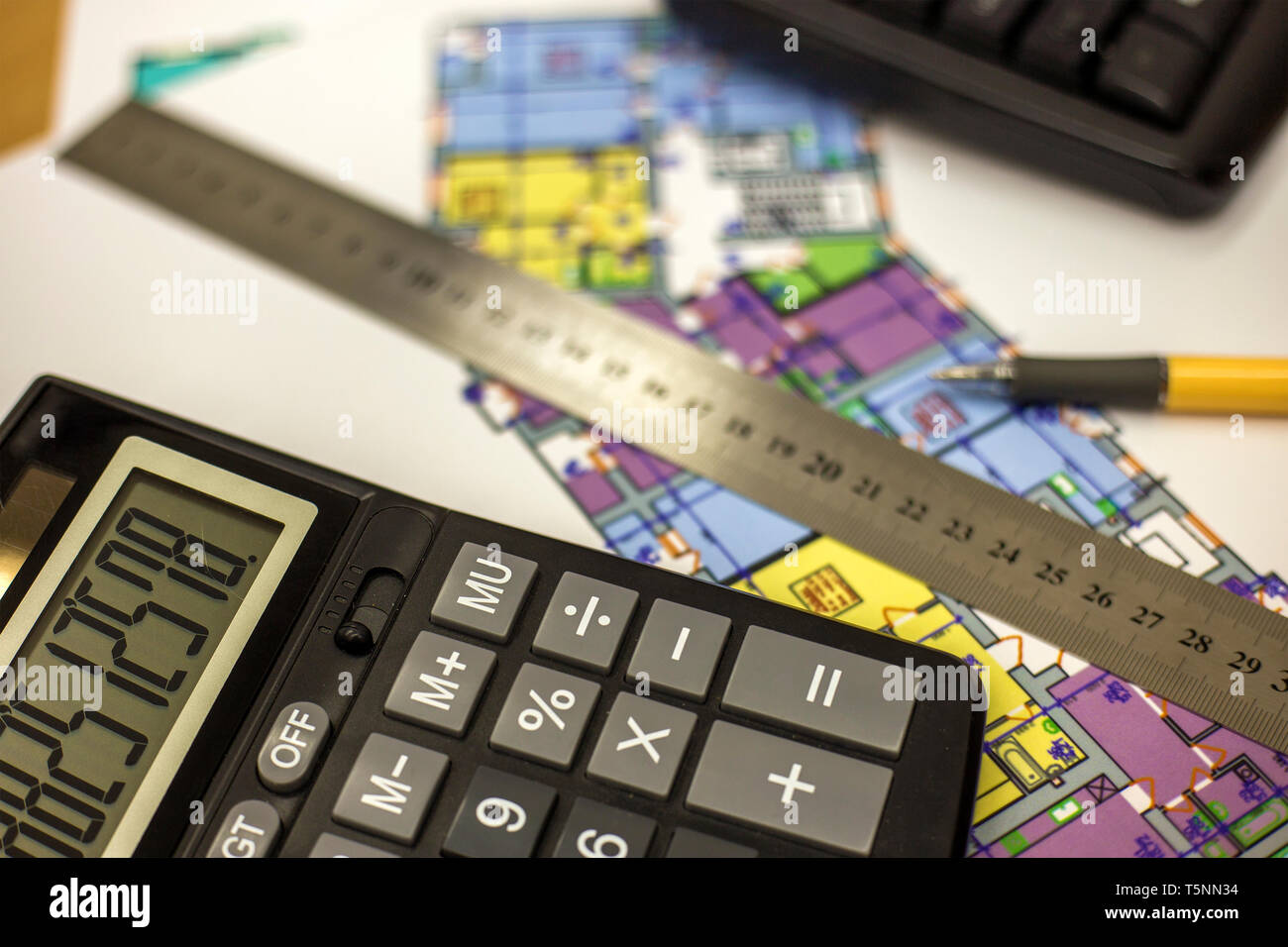 Top view of calculator, pen and ruler on blueprint plan of architecture ...