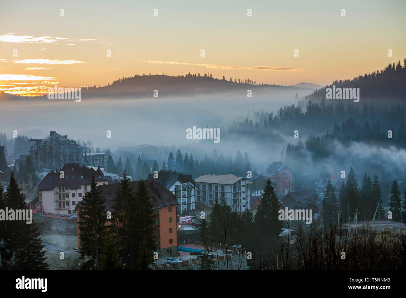 Resort village houses buildings on background of foggy blue mountain ...