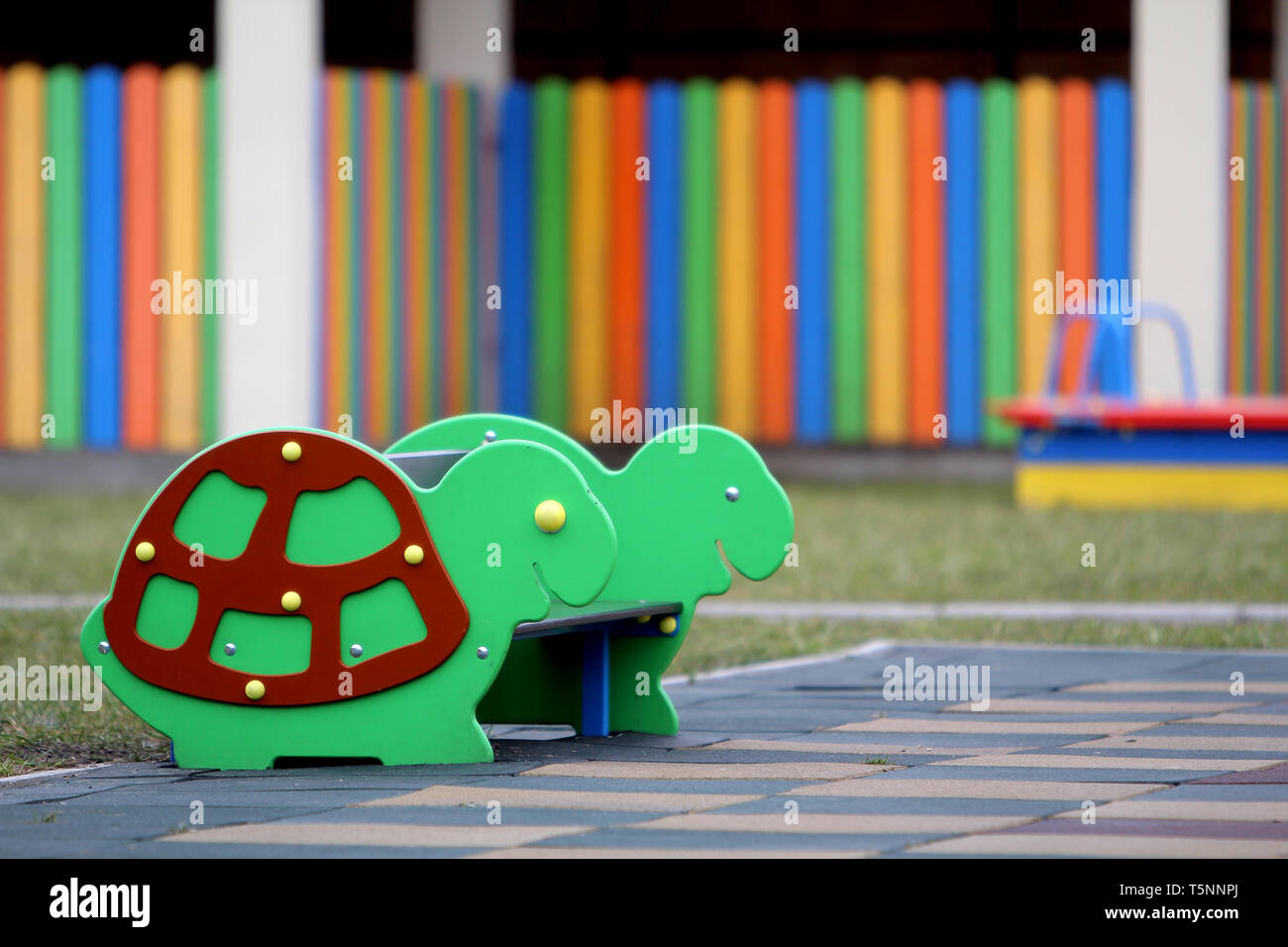 Bright colorful funny bench on nursery playground with soft rubber ...