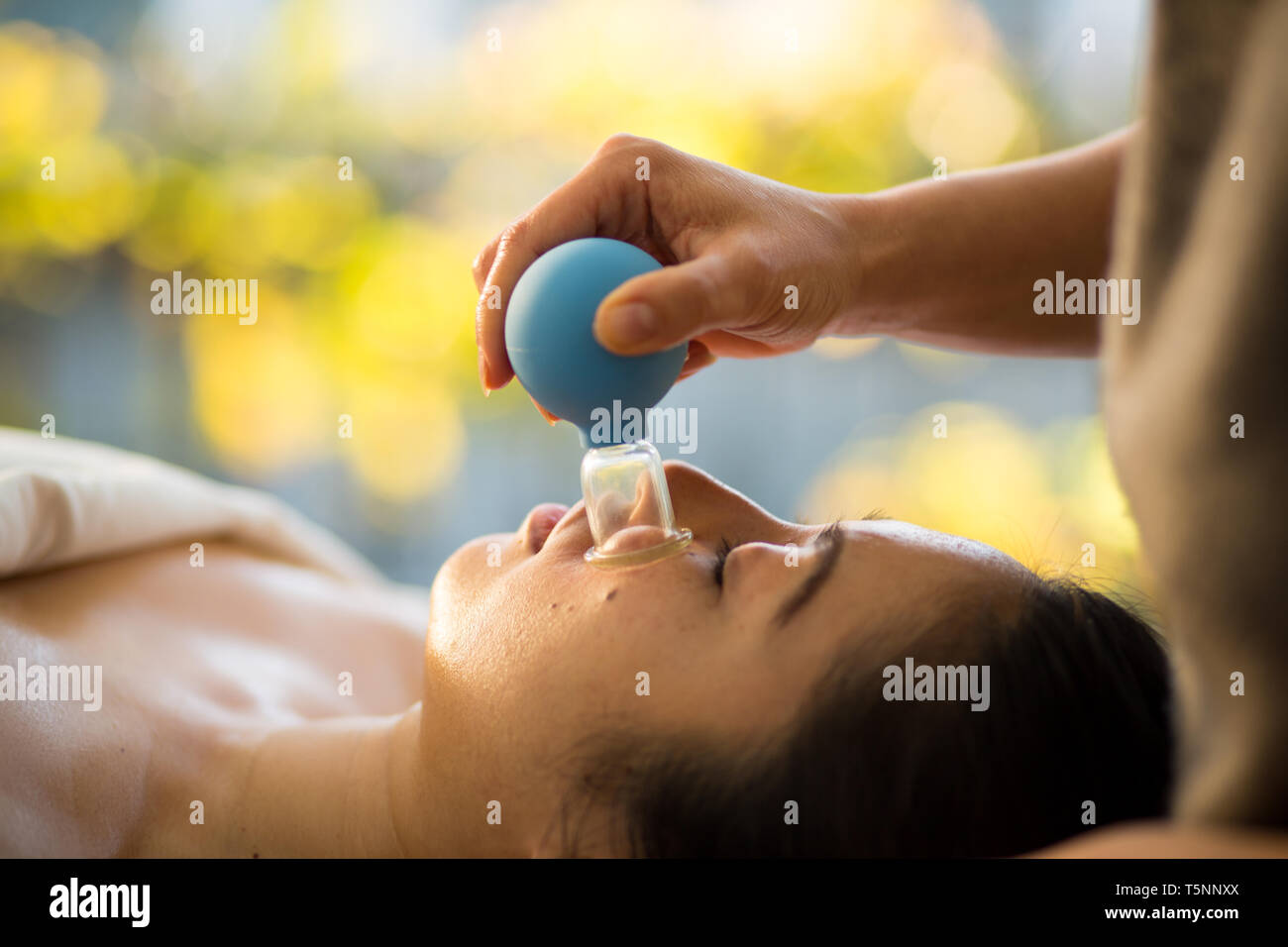 Young Woman receives facial cupping massage facial rejuvenation ...