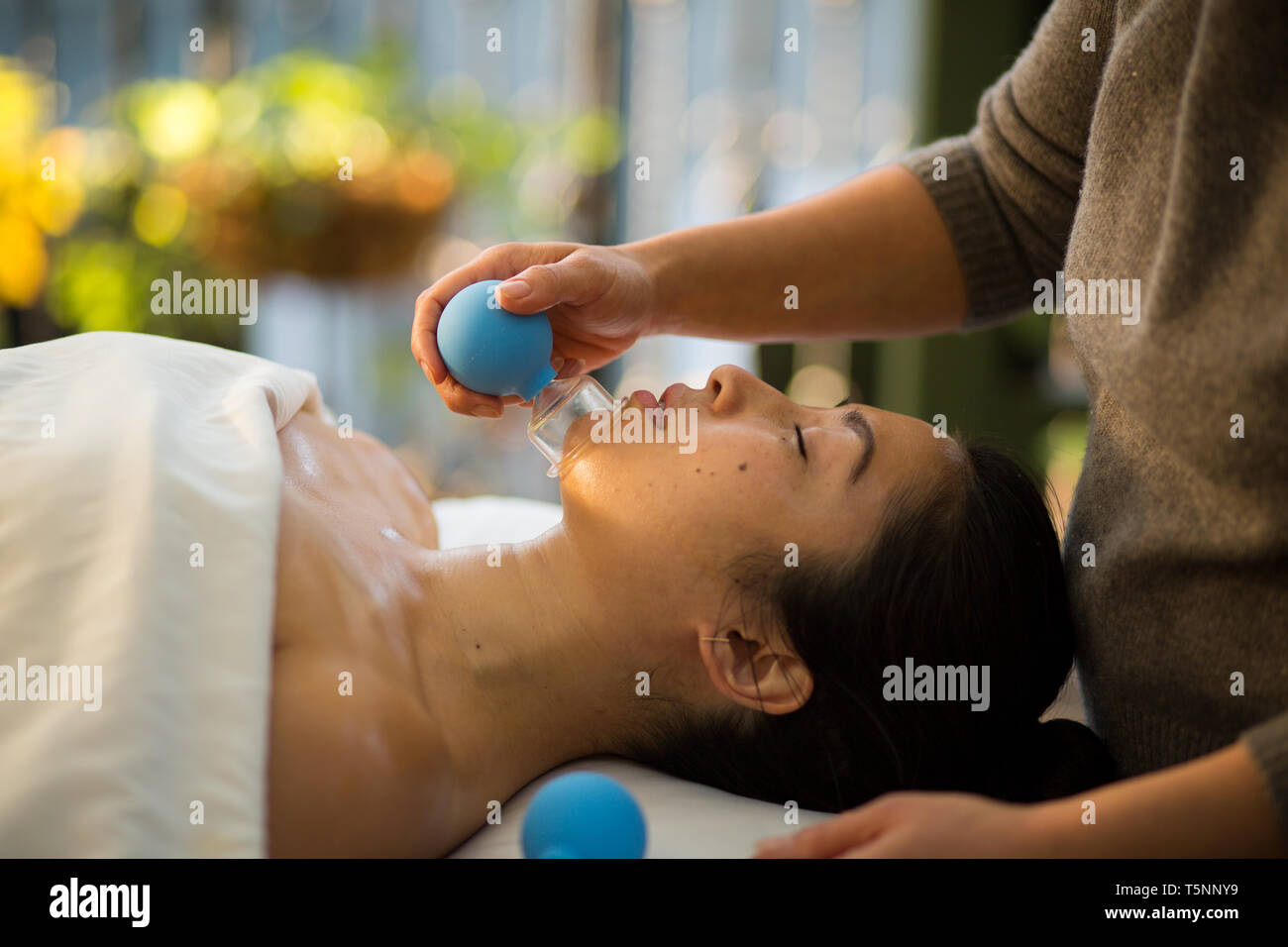 Young Woman receives facial cupping massage facial rejuvenation ...