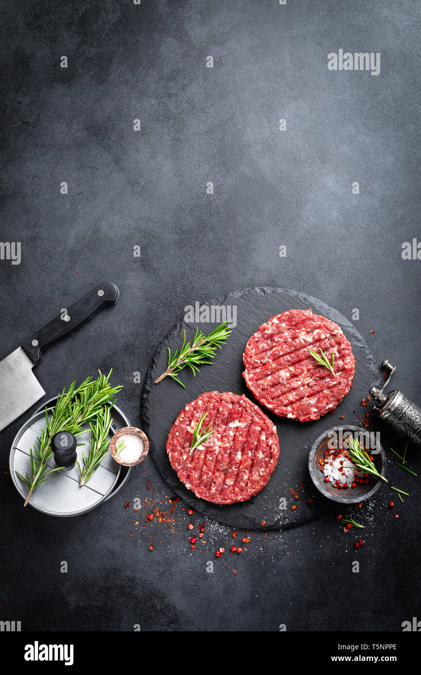 Fresh raw minced beef steak burgers with spices Stock Photo - Alamy