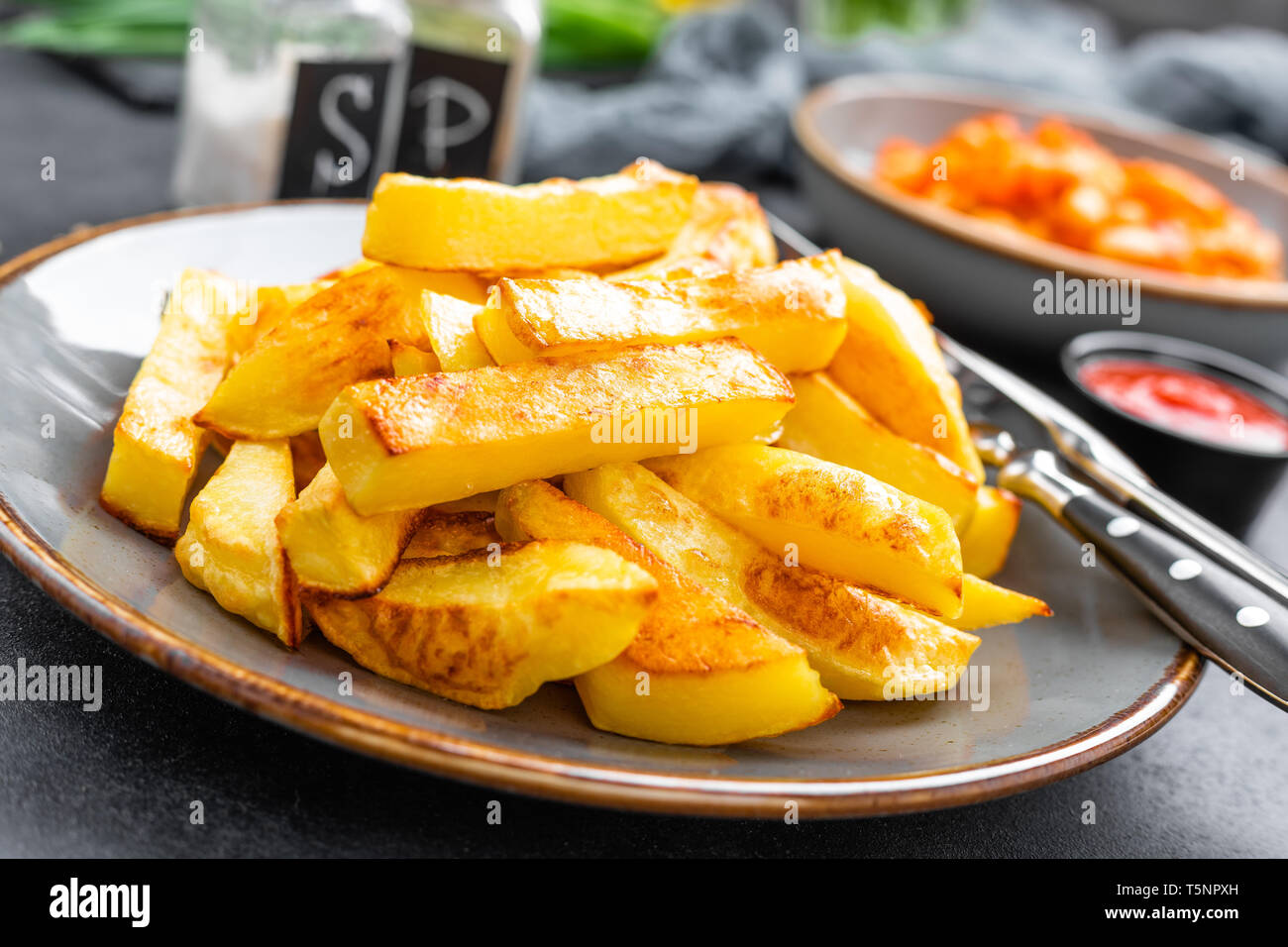Baked, fried potato on plate Stock Photo - Alamy