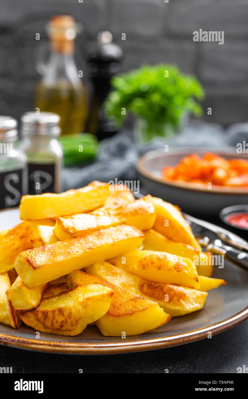 Baked, fried potato on plate Stock Photo - Alamy
