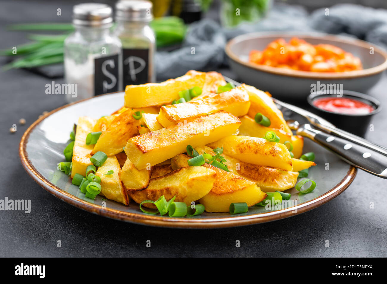 Baked, fried potato on plate Stock Photo - Alamy