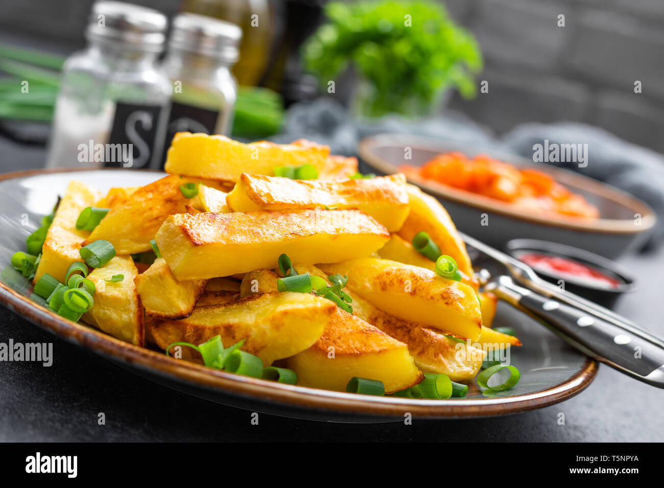 Baked, fried potato on plate Stock Photo - Alamy