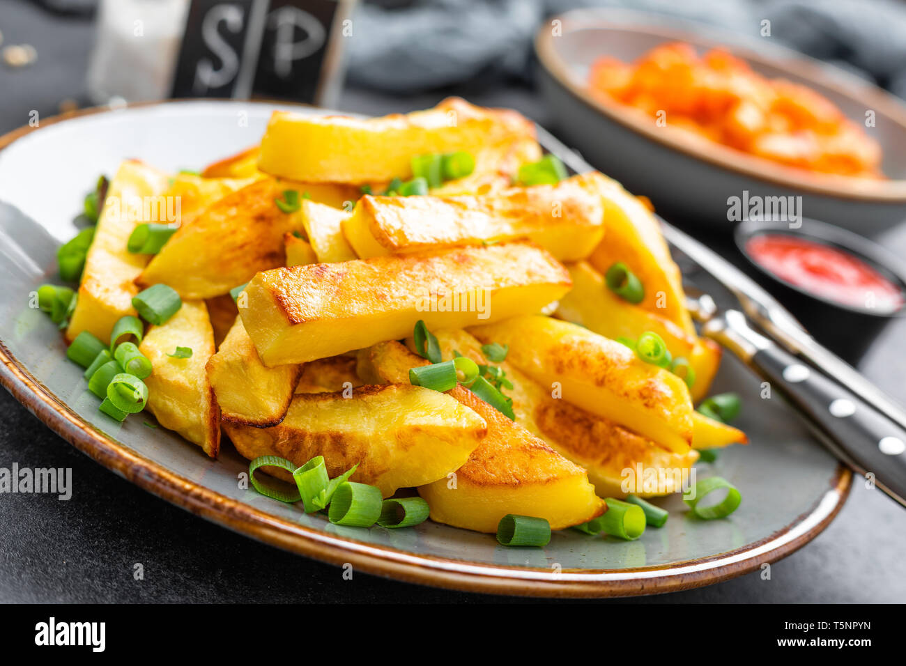Baked, fried potato on plate Stock Photo - Alamy