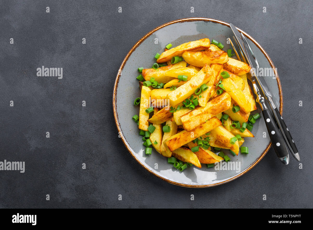 Baked, fried potato on plate Stock Photo - Alamy