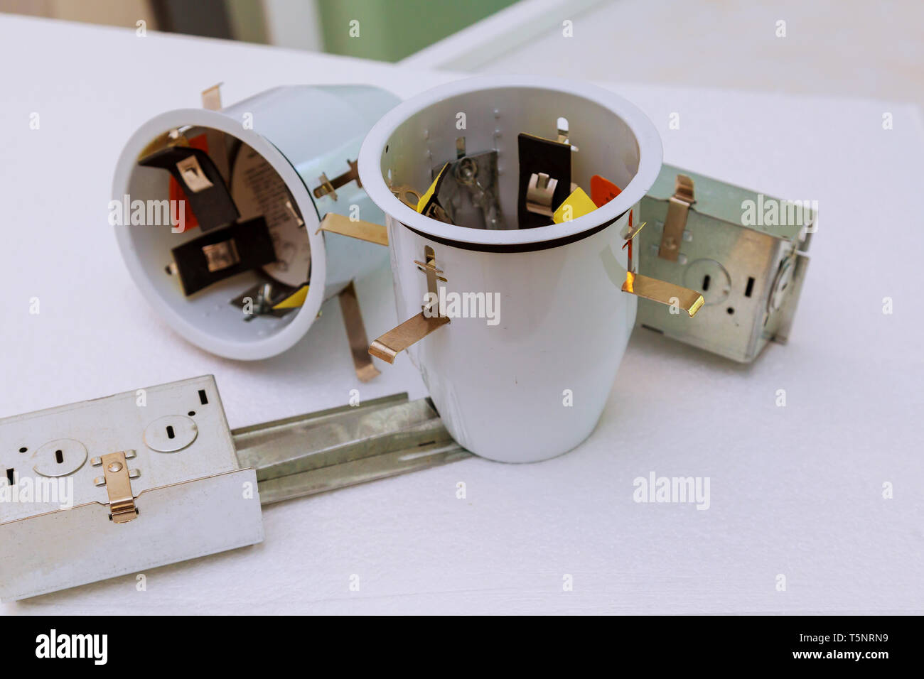 The electrician assembles ceiling lights system installation in the ...