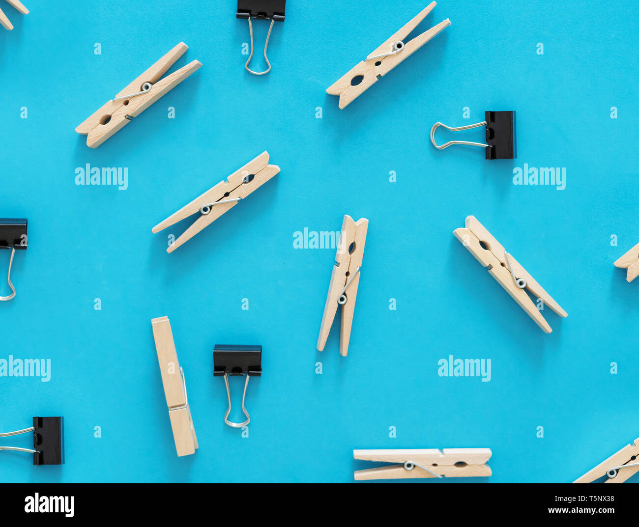 Binder clips and wooden clips on blue backgrounds Stock Photo - Alamy