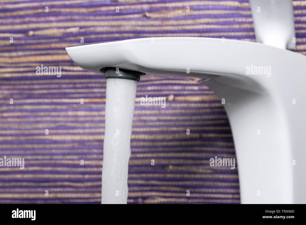 The water tap with water stream and drops. Faucet for the bathroom and ...