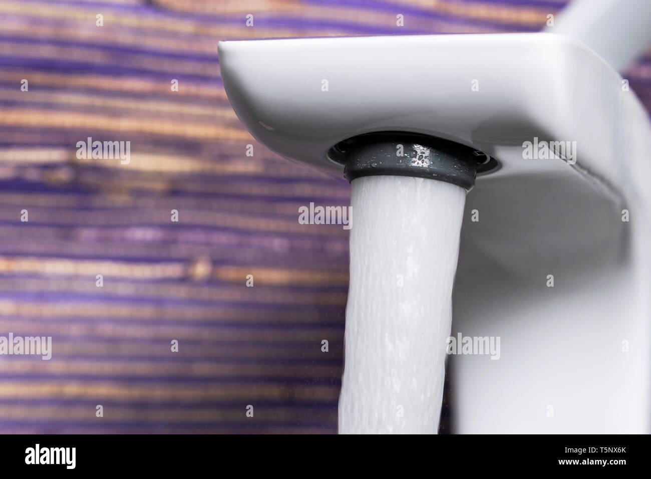 The water tap with water stream and drops. Faucet for the bathroom and ...