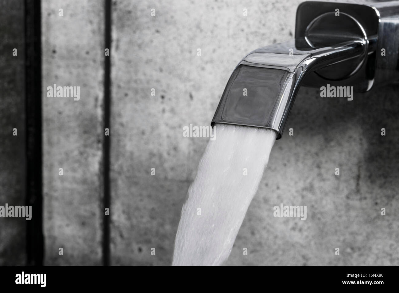 The water tap with water stream and drops. Faucet for the bathroom and ...