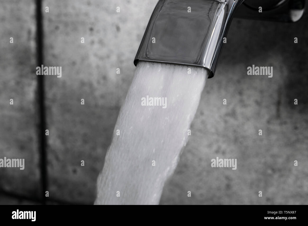 The water tap with water stream and drops. Faucet for the bathroom and ...