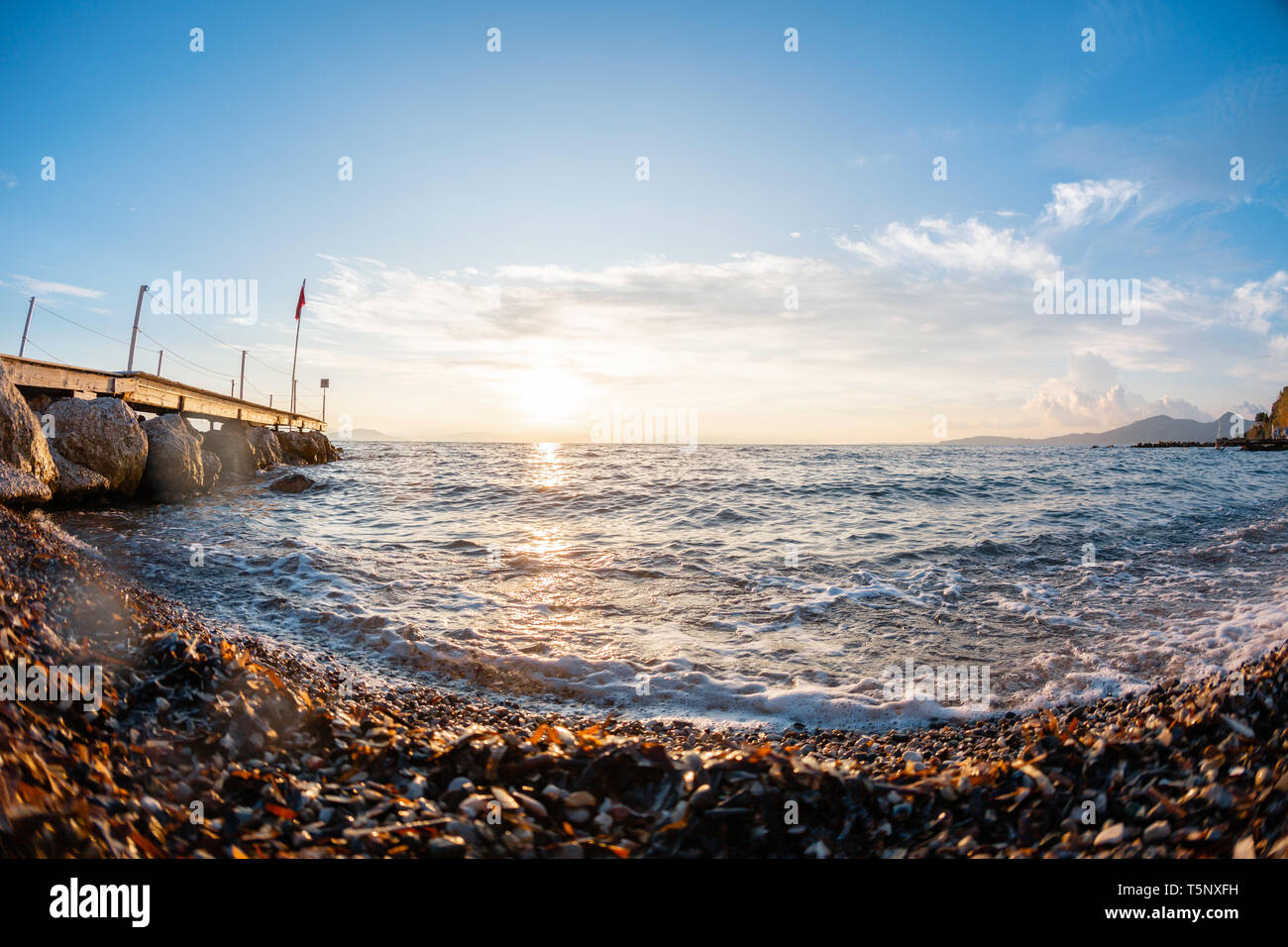 Summer sunrise on coast, Corfu island, Greece. Beach with perfect views of the mainland Greece ...