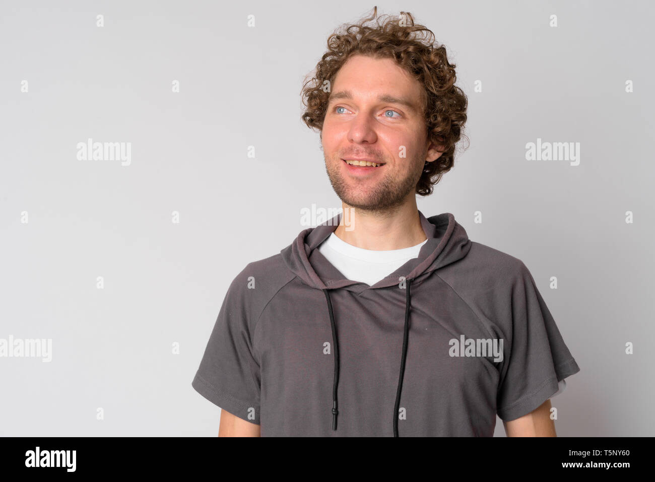 Face of happy handsome man with curly hair smiling Stock Photo - Alamy
