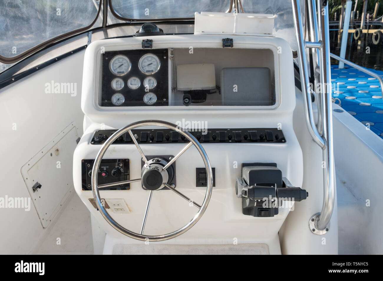 White yacht speed control panel with steering wheel Stock Photo - Alamy