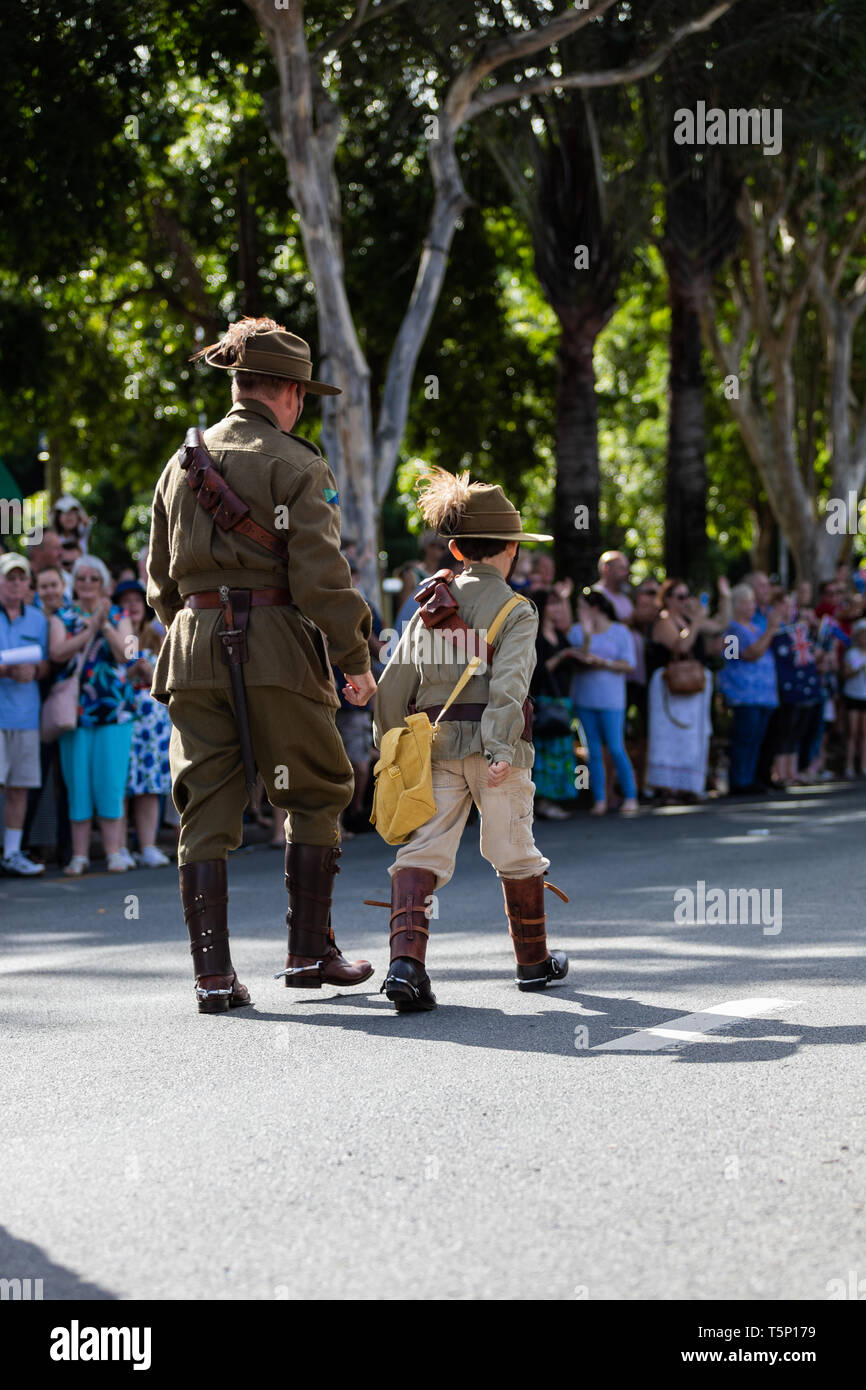 Father and young son proudly walking together dressed in traditional ...