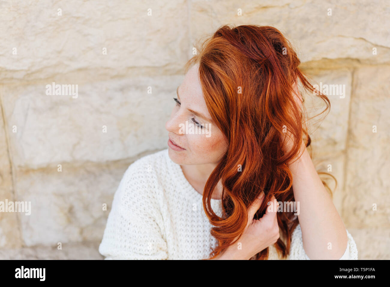 Woman running her hands through her hair hi-res stock photography and ...