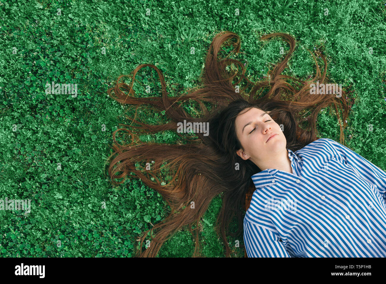 Young woman lying on grass spring hi-res stock photography and images ...