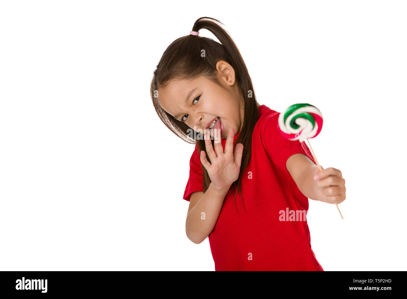 cute little girl with candy lollipop doing stop sign isolated on white ...