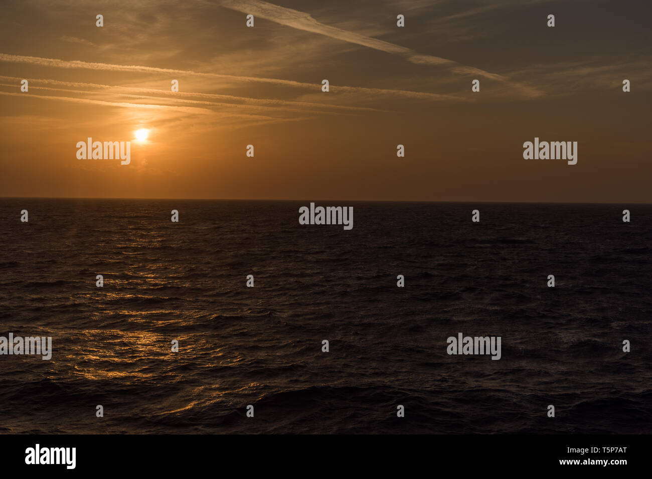 Orange sunset above sea from ship Stock Photo - Alamy