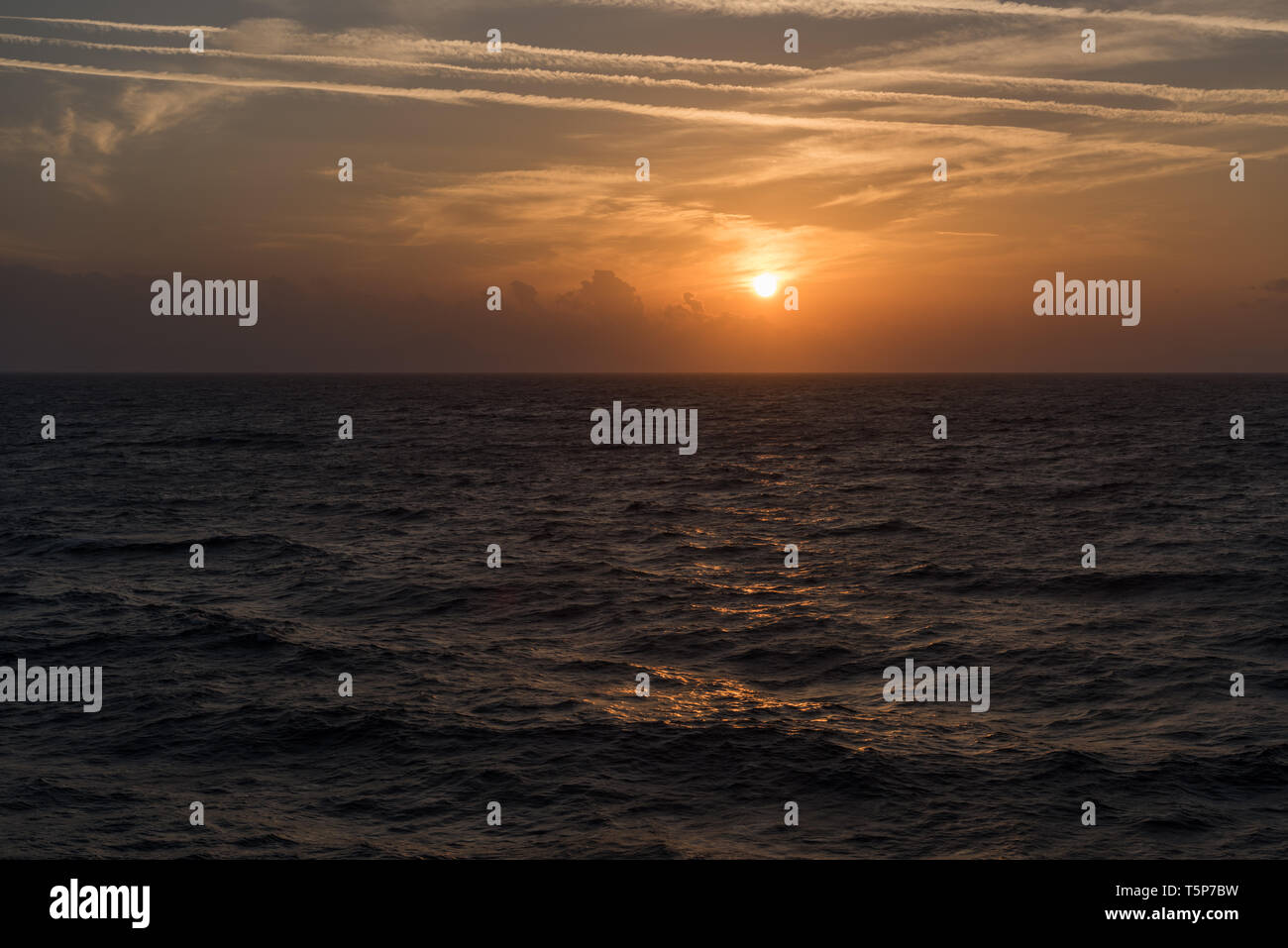 Orange sunset above sea from ship Stock Photo - Alamy