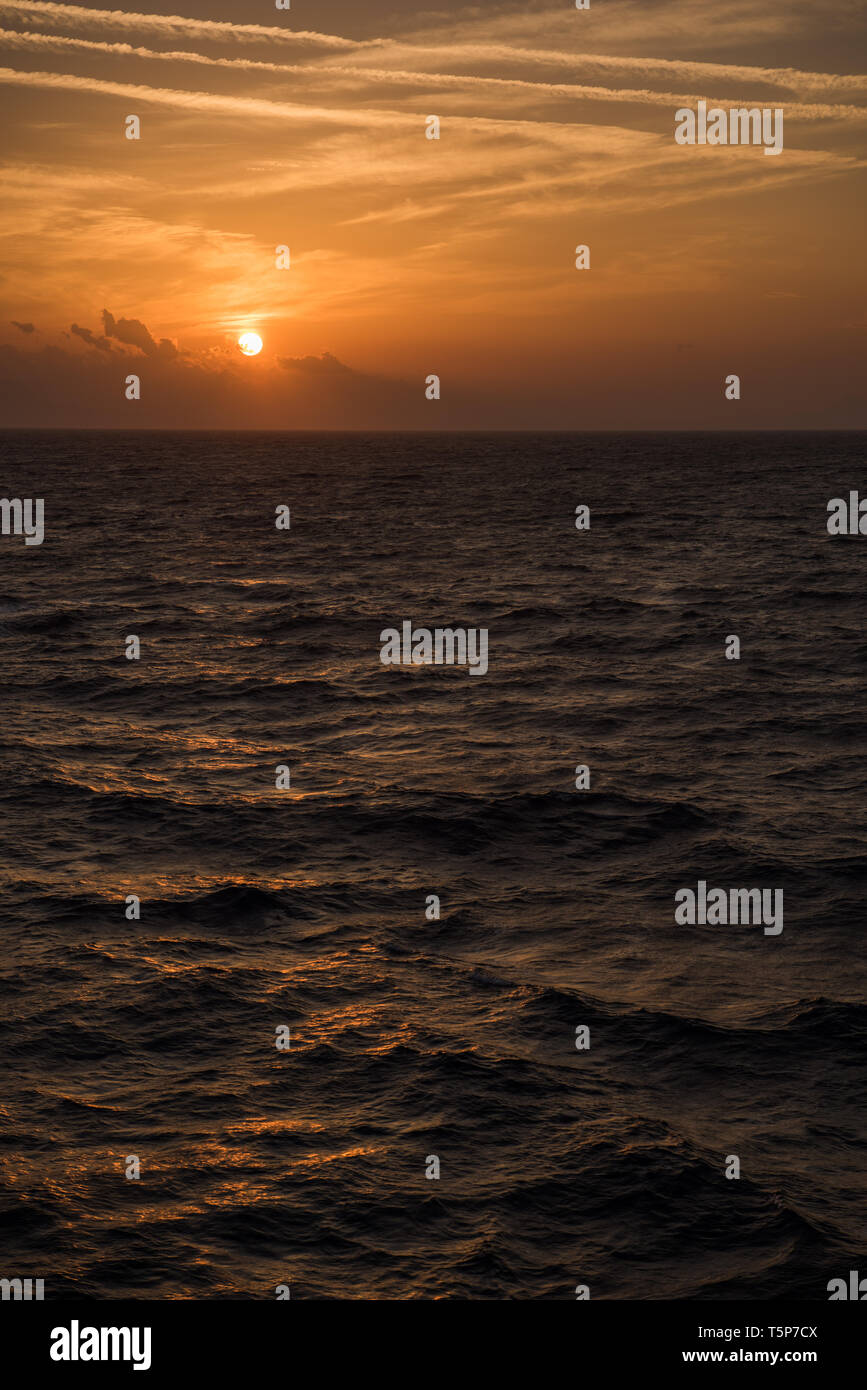 Orange sunset above sea from ship Stock Photo - Alamy