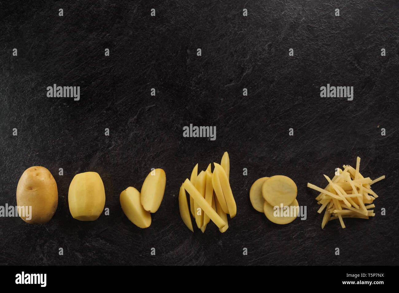 Different cuts of potatoes on a black textured background. Photo taken ...