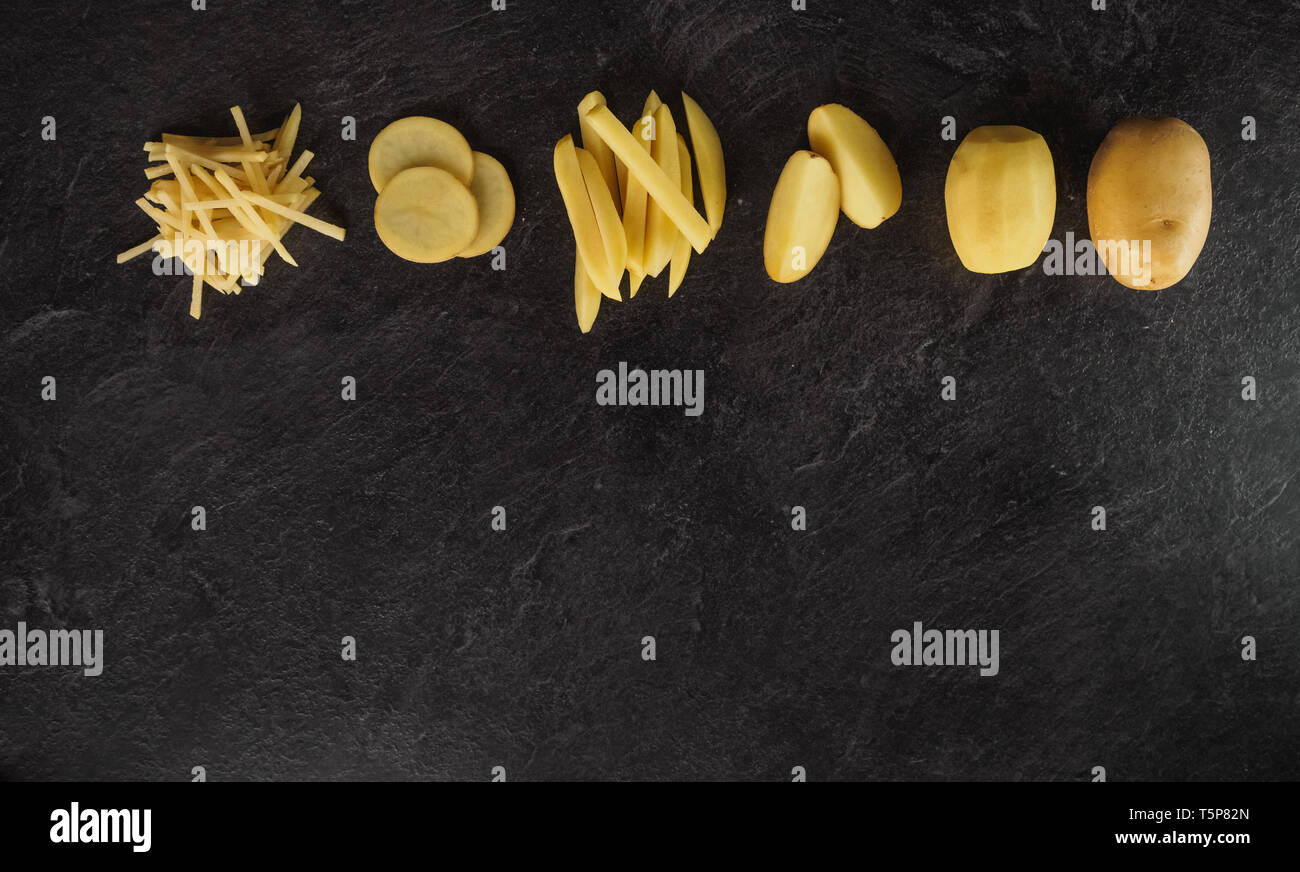 Different cuts of potatoes on a black textured background. Photo taken ...