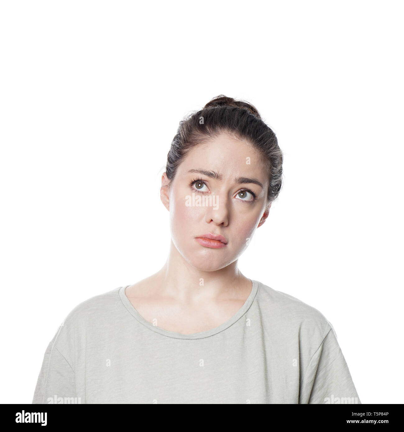 worried thoughtful young woman with concerned look on her face looking ...