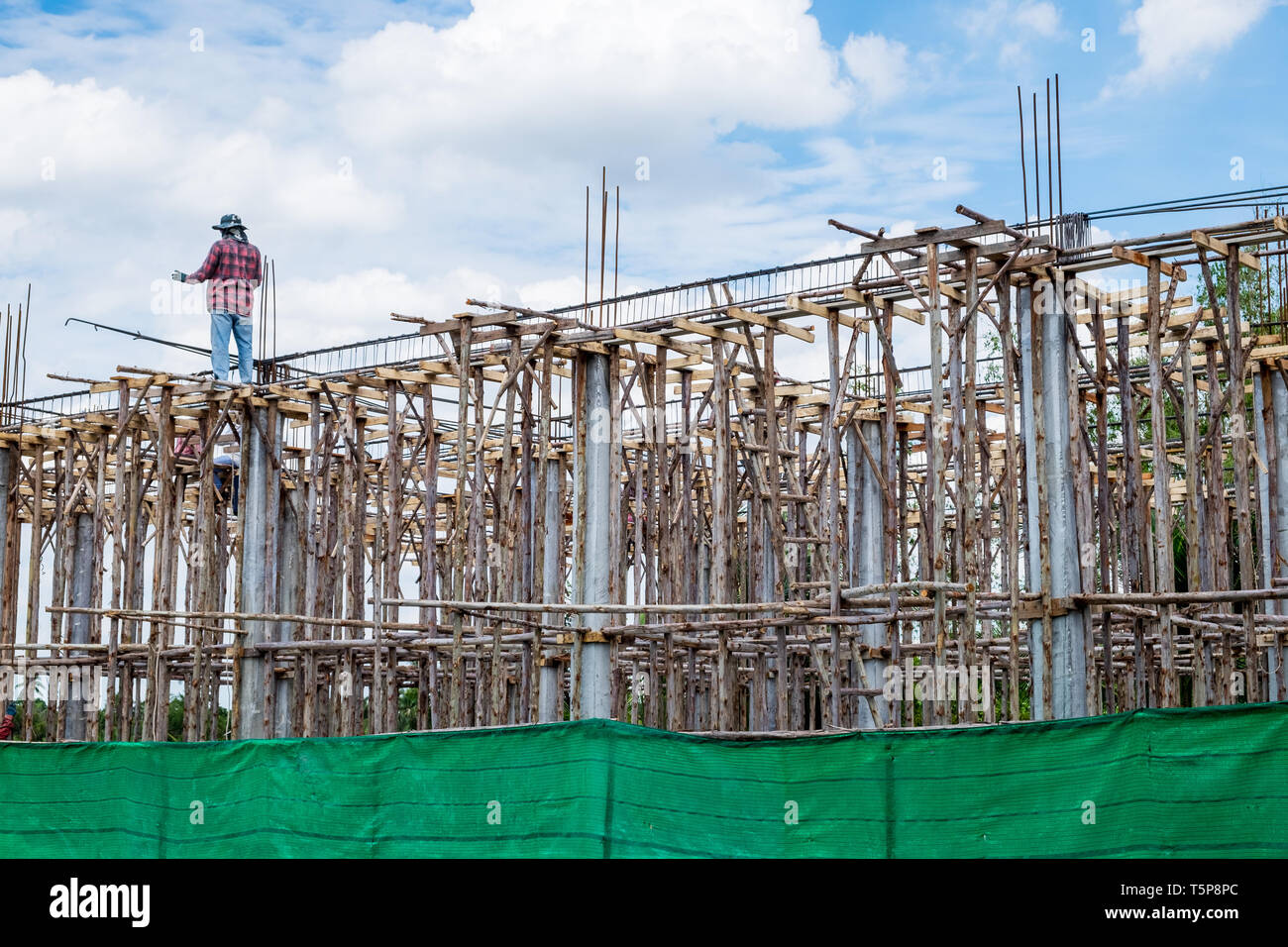 Construction work with wood steel mortar and people Stock Photo - Alamy