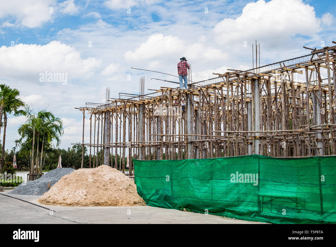 Construction work with wood steel mortar and people Stock Photo - Alamy