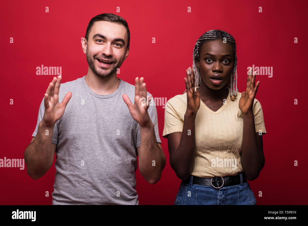 Shocked African American young female and male look with scared ...