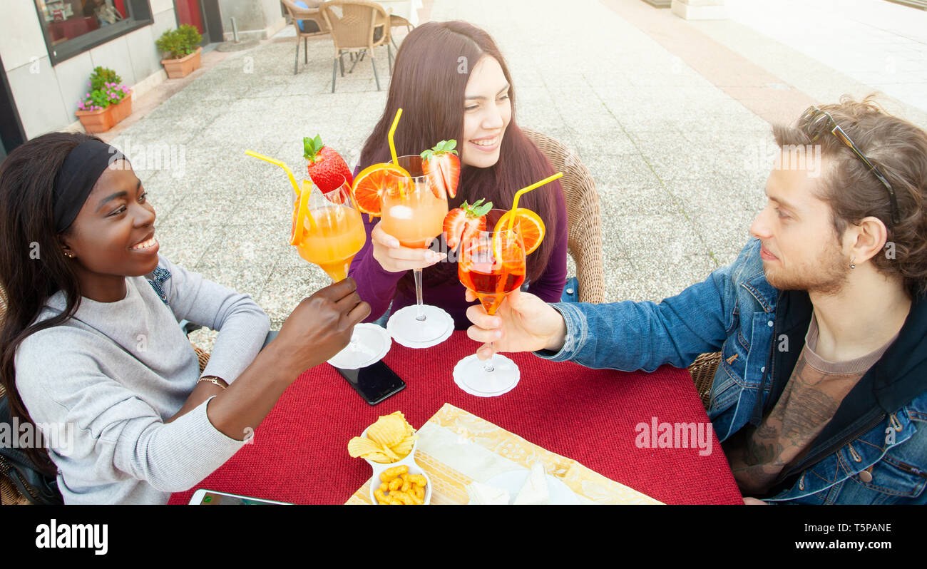 Three friends toast with cocktails celebrating friendship Stock Photo ...